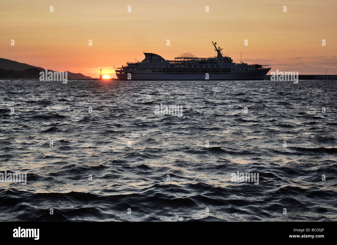 Cruise ship in sunset Stock Photo - Alamy