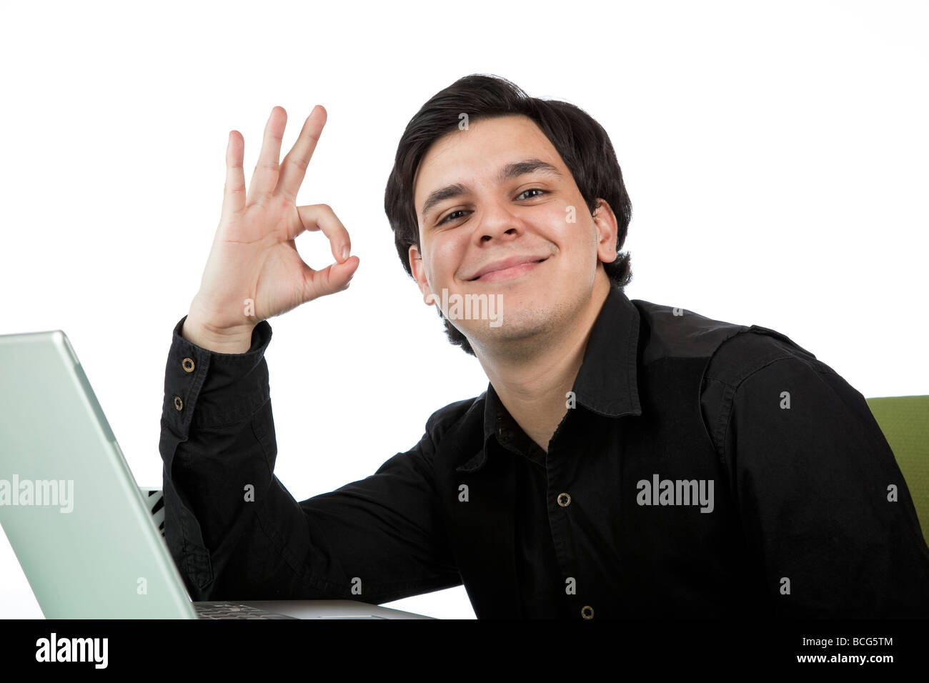 Latino man giving a okay hand gesture Stock Photo - Alamy