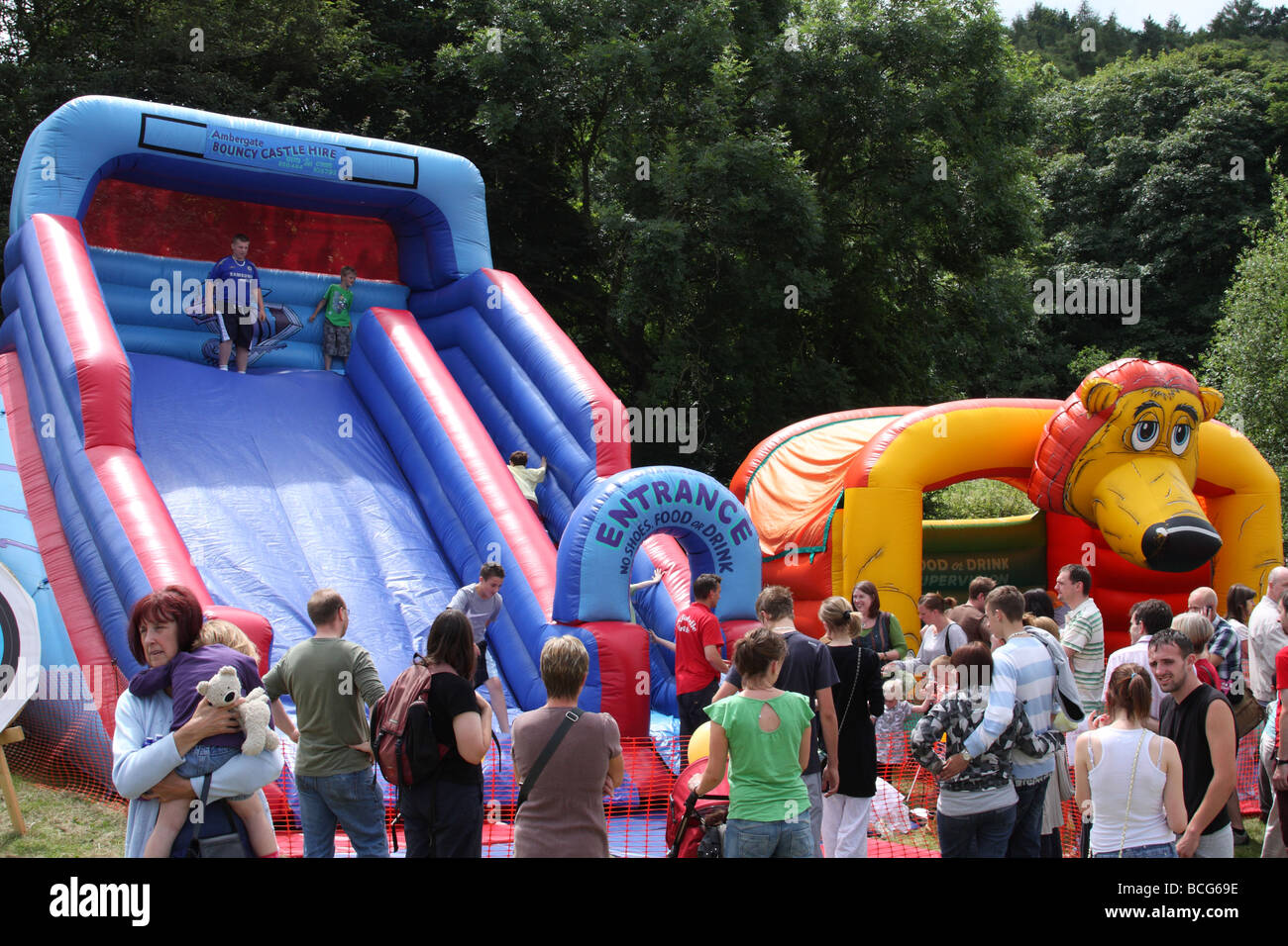 Children on an inflatable slide at an English village show. Ambergate ...