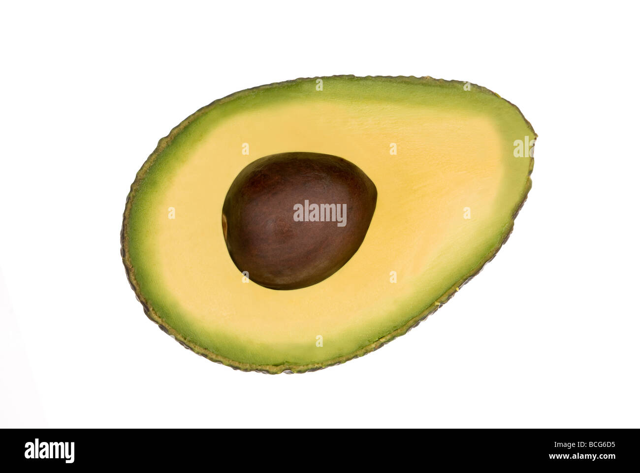 A ripe avocado cut in half isolated on a white background Stock Photo ...