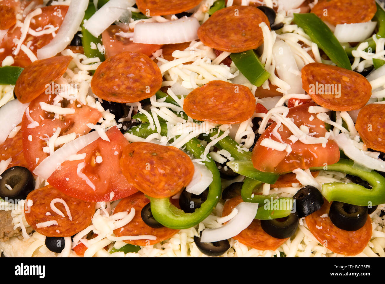 A pizza with the works before it is cooked and placed in the oven Stock ...