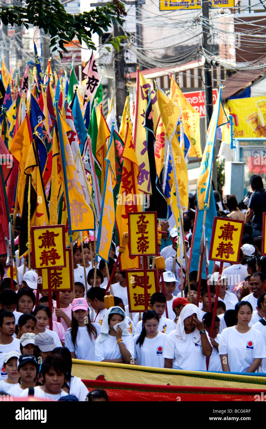 Thai boys and girls carrying flags during street procession at Phuket ...