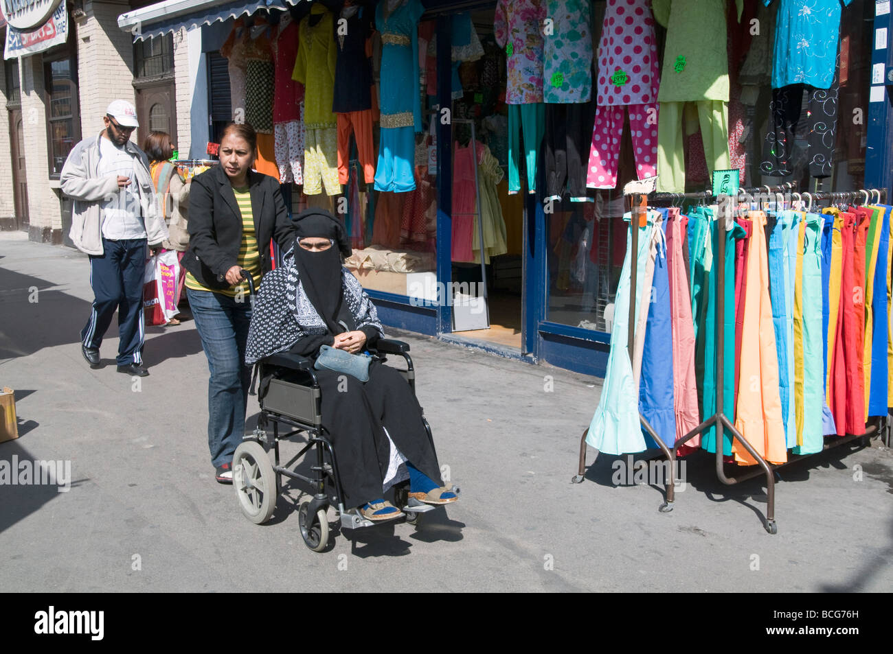 UK. DISABLED MUSLIM WOMAN IN WHEELCHAIR AT WHITECHAPEL MARKET IN EAST ...