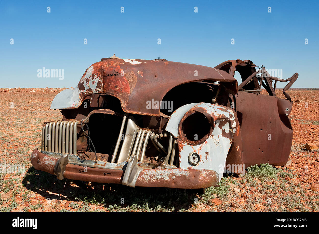 Rusted wreck of car dumped in desert Stock Photo - Alamy