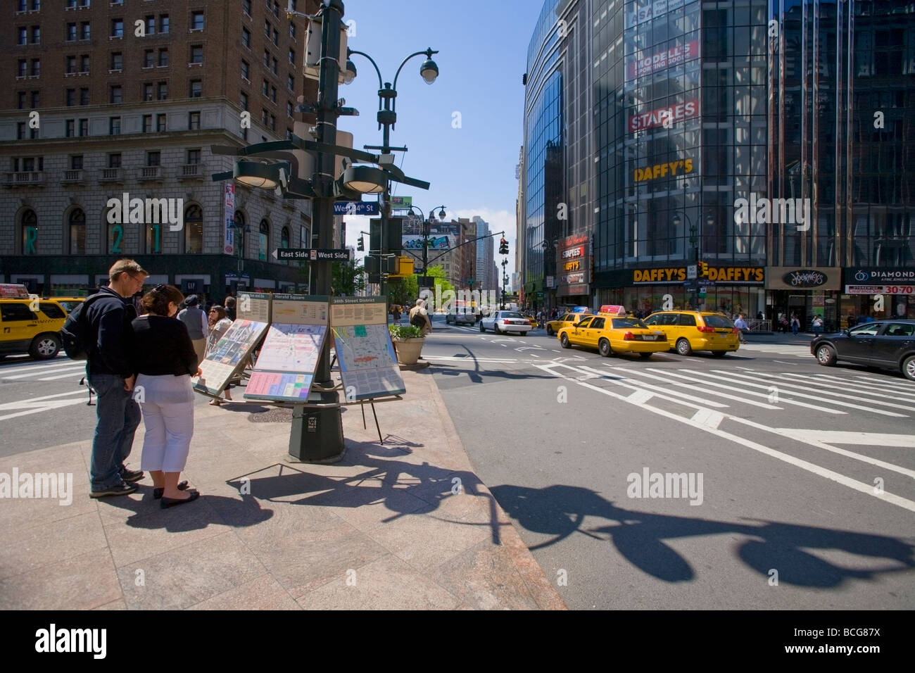 tourists looking at maps and information at Herald Square, New York ...