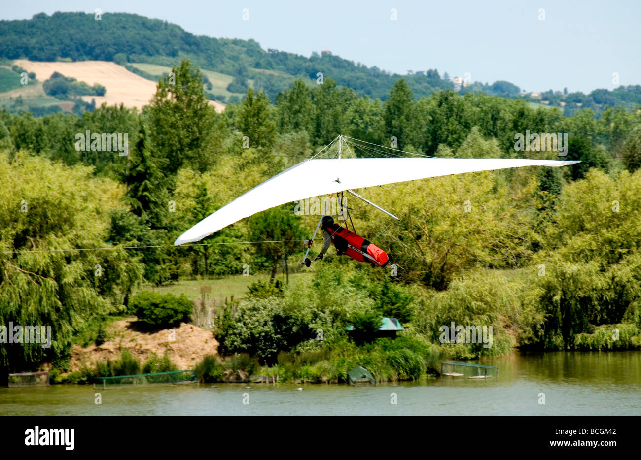 Hang glider taking off by a lake at an airshow in France Stock Photo ...