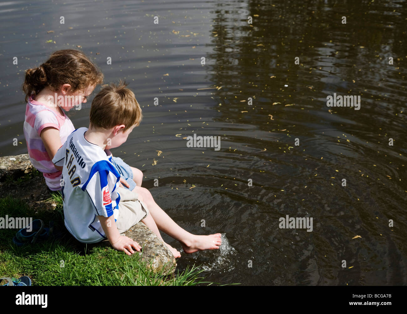 Children Splashing in a Village Pond Stock Photo - Alamy
