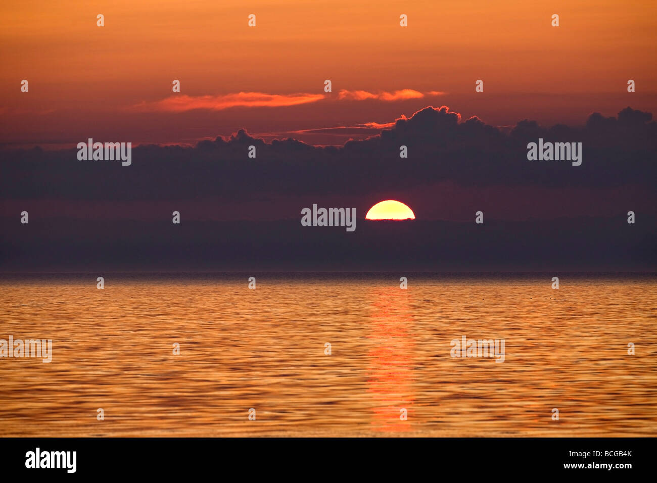 Sunset into clouds Stock Photo - Alamy