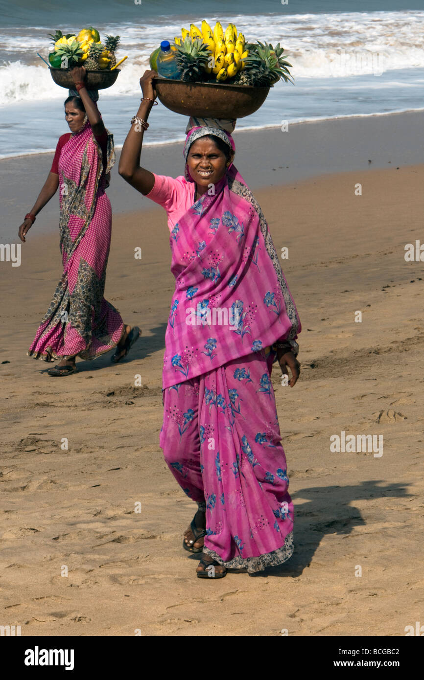 Woman beach fruit seller Anjuna weekly hippy flea market Goa India ...
