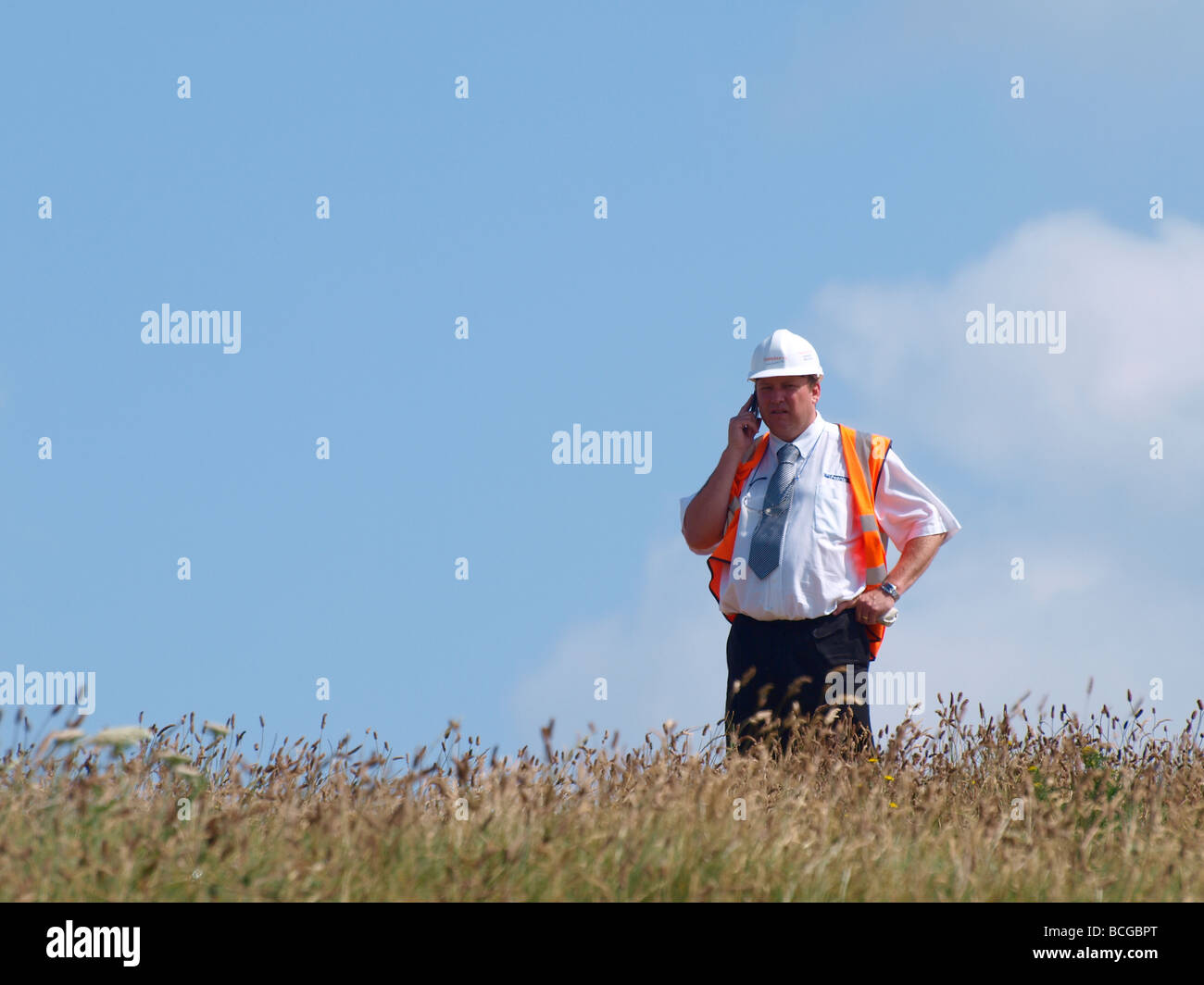 Workman using mobile Stock Photo - Alamy