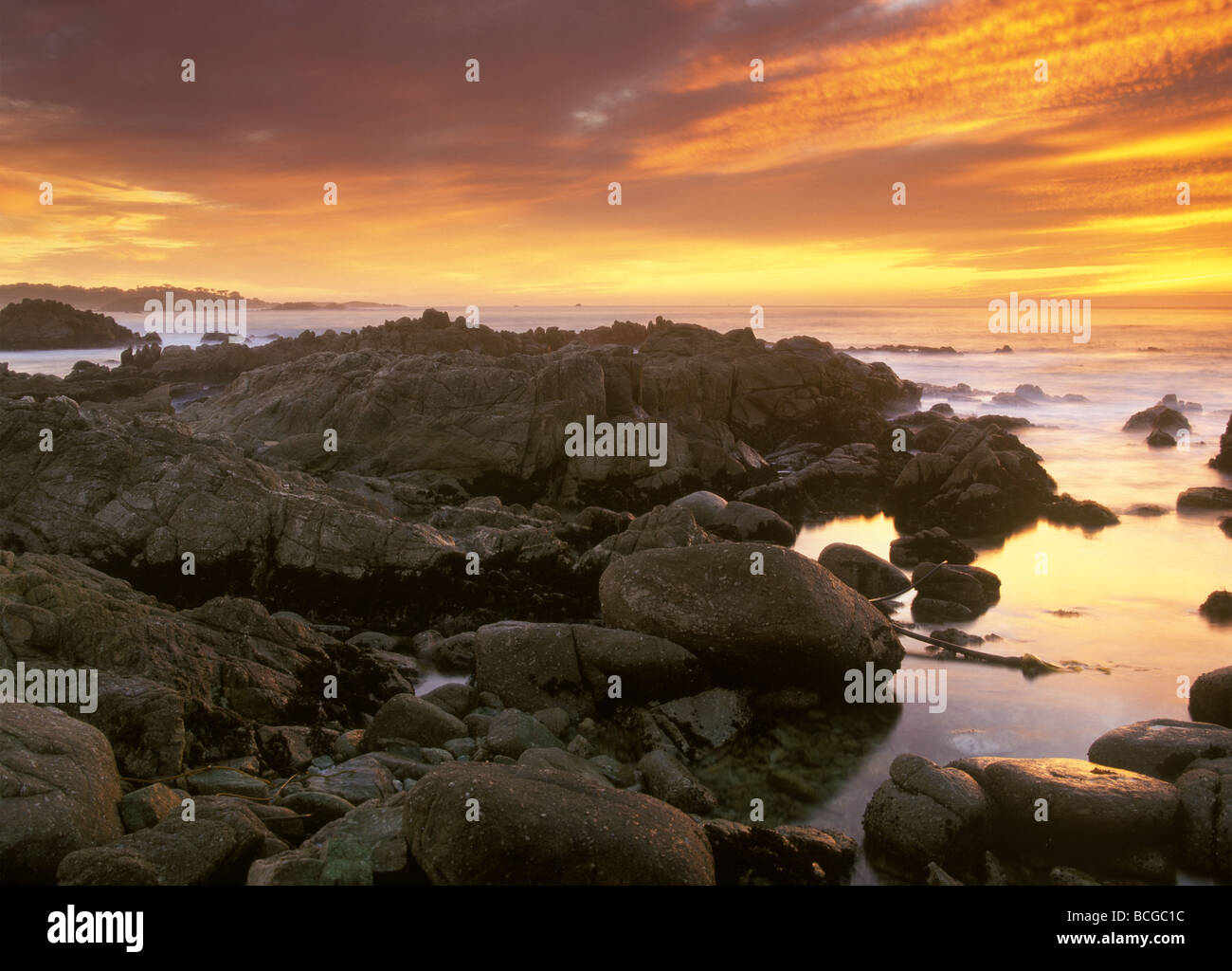Pebble beach sunset orange sky rocky coast asilomar beach hi-res stock ...
