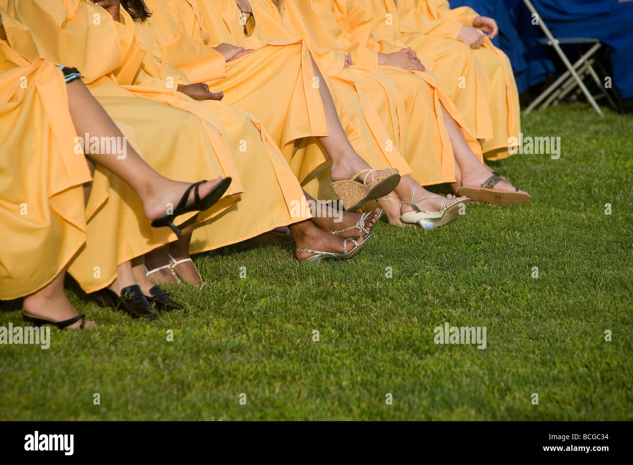 High School students wearing blue and gold cap and gown attend ...