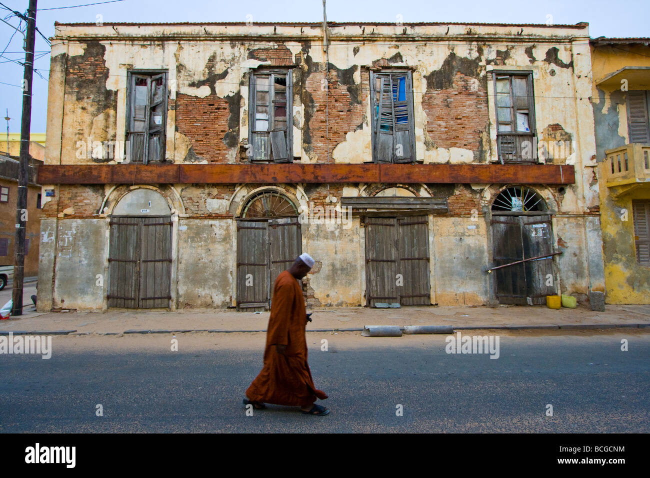 Muslim Man and a Colonial Building in St Louis in Senegal West Africa ...