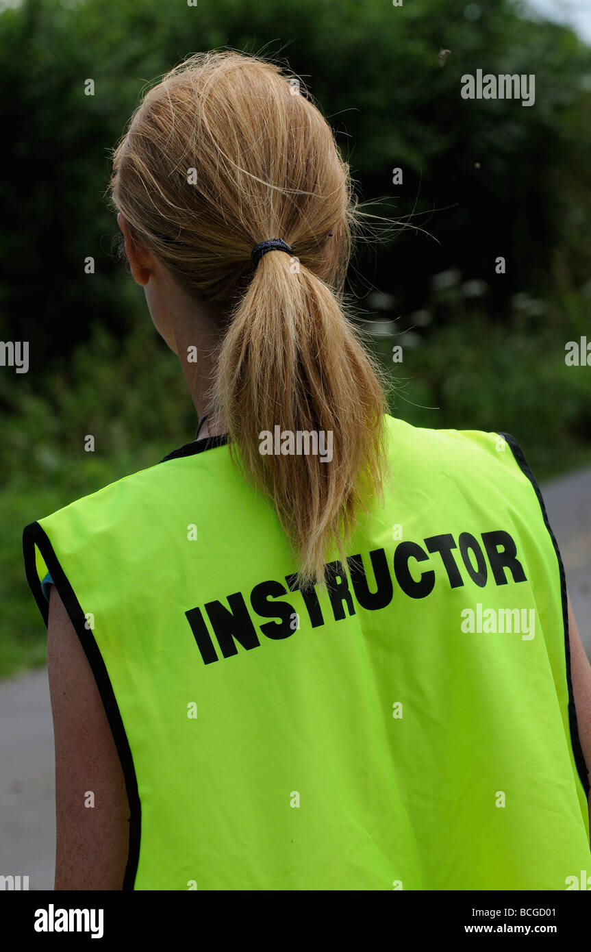 Female instructor wearing a high visibility reflective safety jacket ...