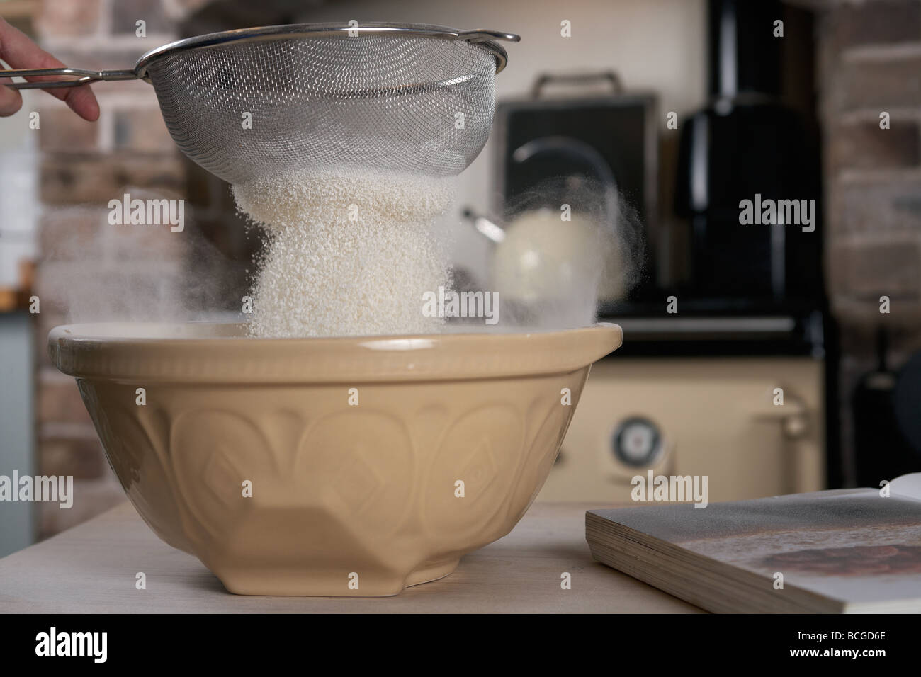 Plain flour being sieved into a mixing bowl Stock Photo - Alamy
