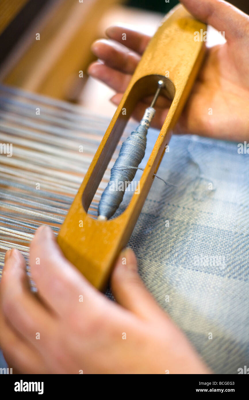 Hands holding a shuttle and weaving Stock Photo - Alamy