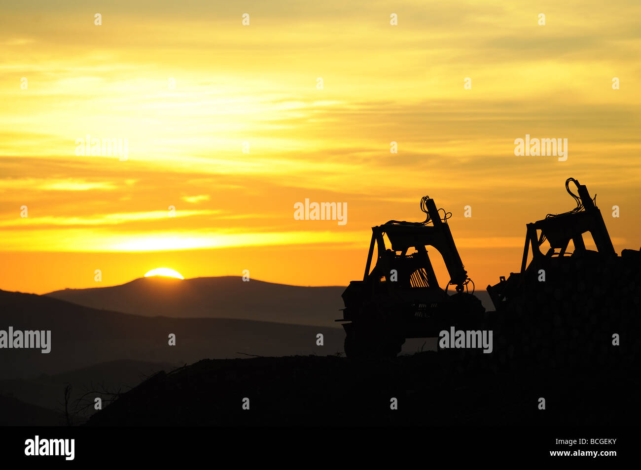 Excavators in sunset Stock Photo - Alamy