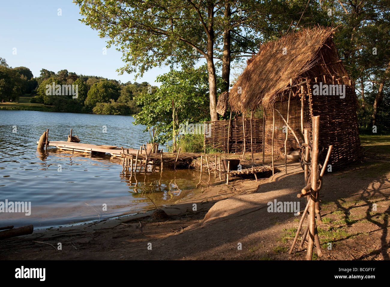 Primative living in stick and reed huts by a lake Stock Photo - Alamy