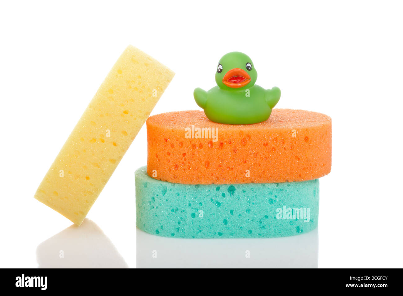 A three sponges and rubber duck reflected on white background Stock ...
