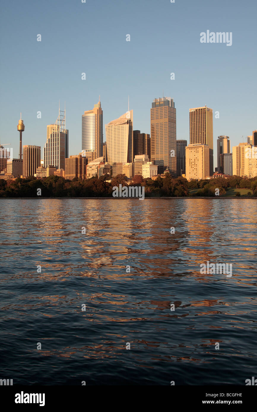 The city skyline bathed with the first rays of sunshine at dawn in ...