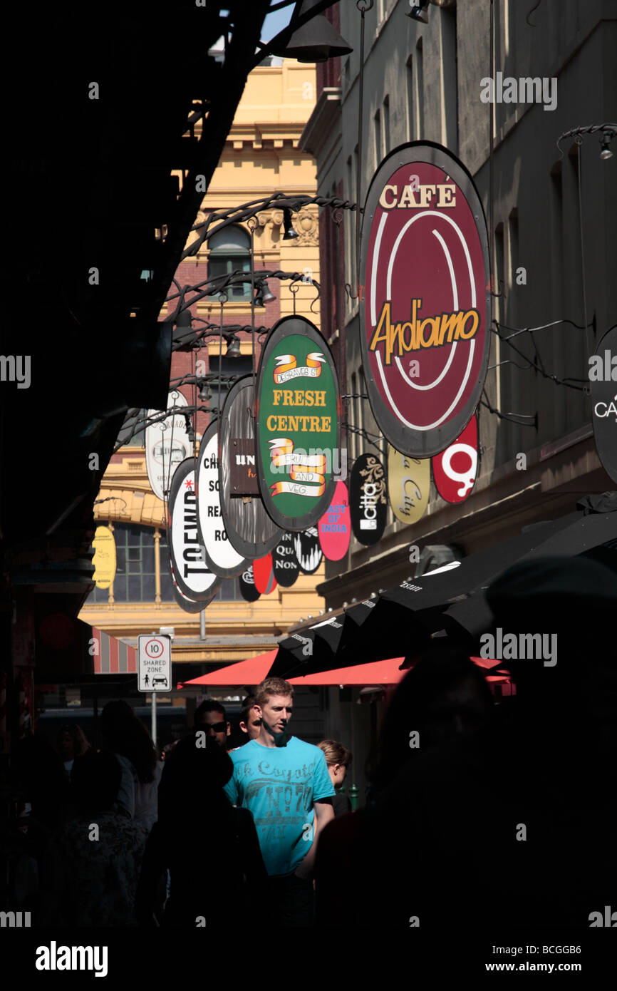 Shop and cafe signs hang over a narrow pedestrian alley in Melbourne ...