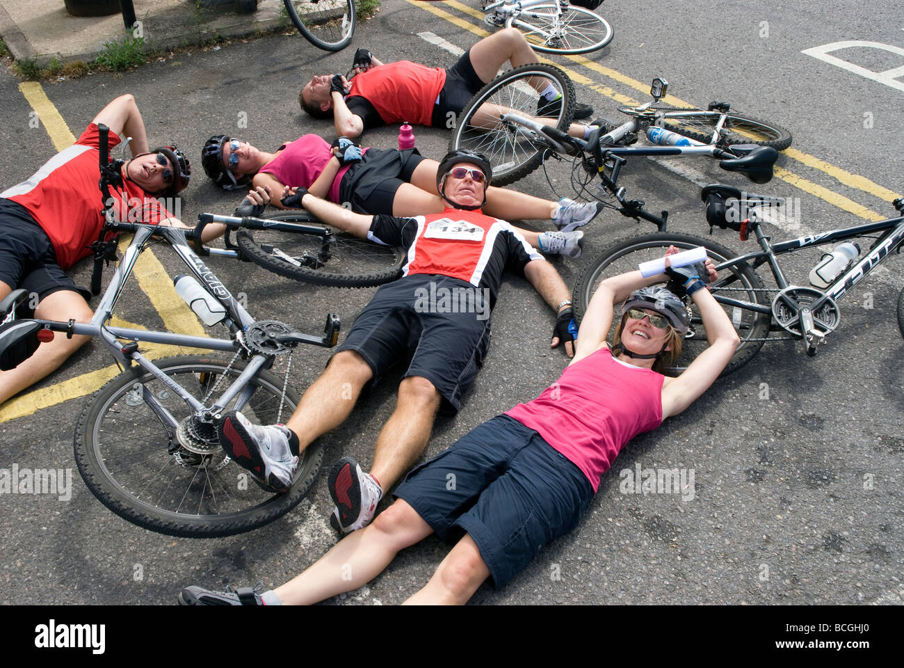 Cyclists taking a well earned rest after completing a charity bike ride ...