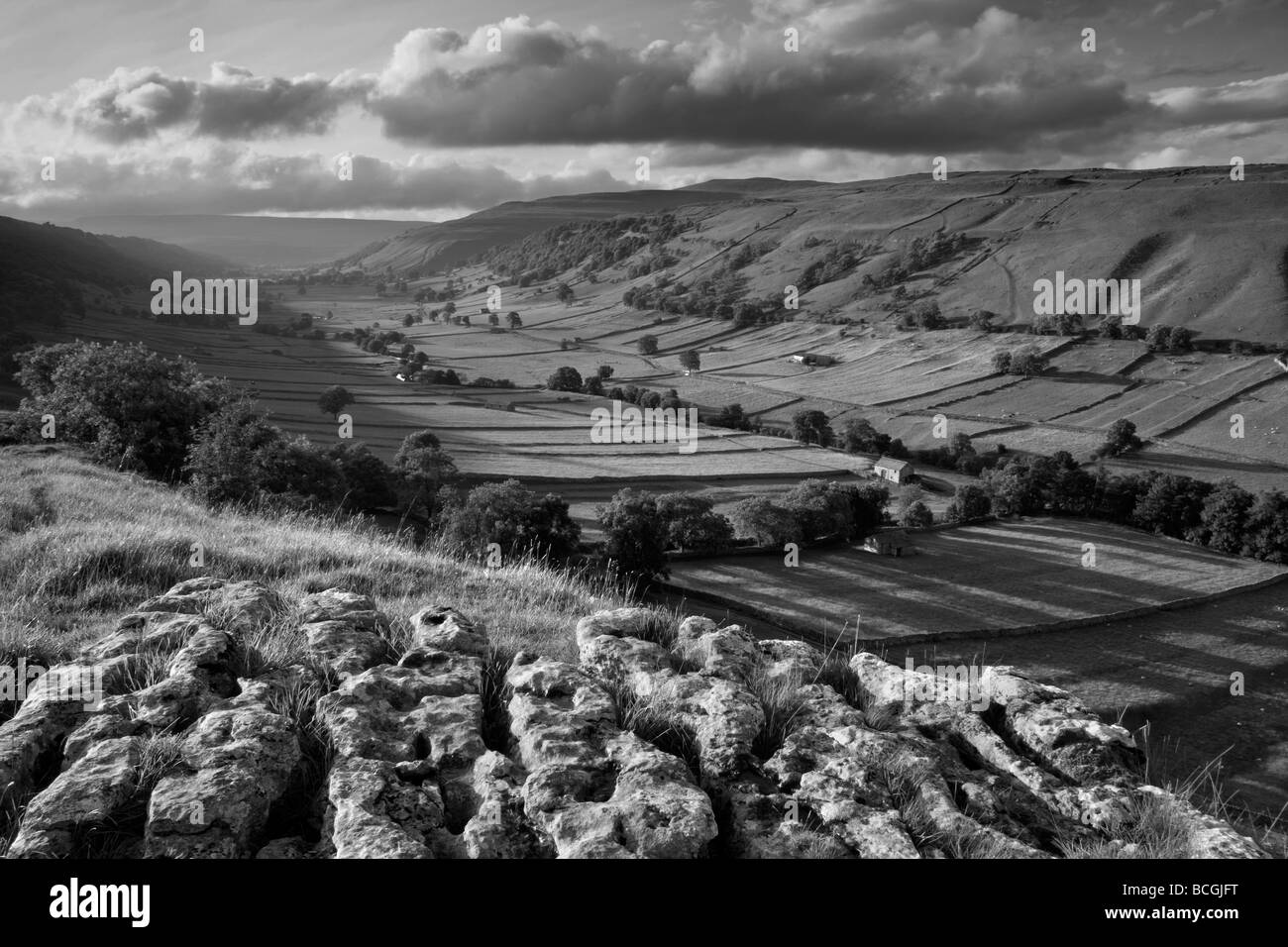 An outcrop of limestone pavement, with a view along the u-shaped valley ...