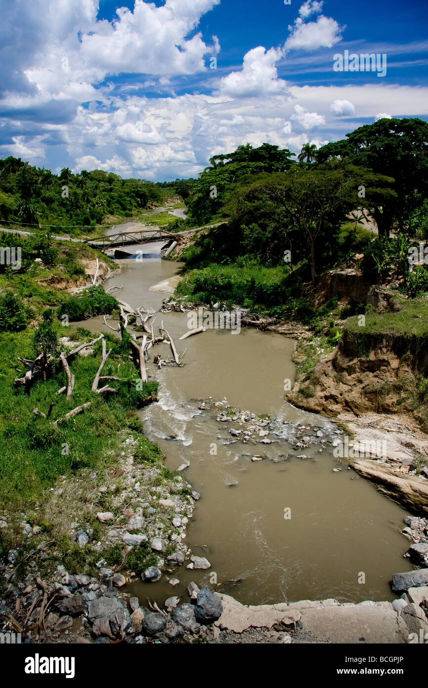 A large valley with lush vegetation divided by a river near Palo Blanco ...