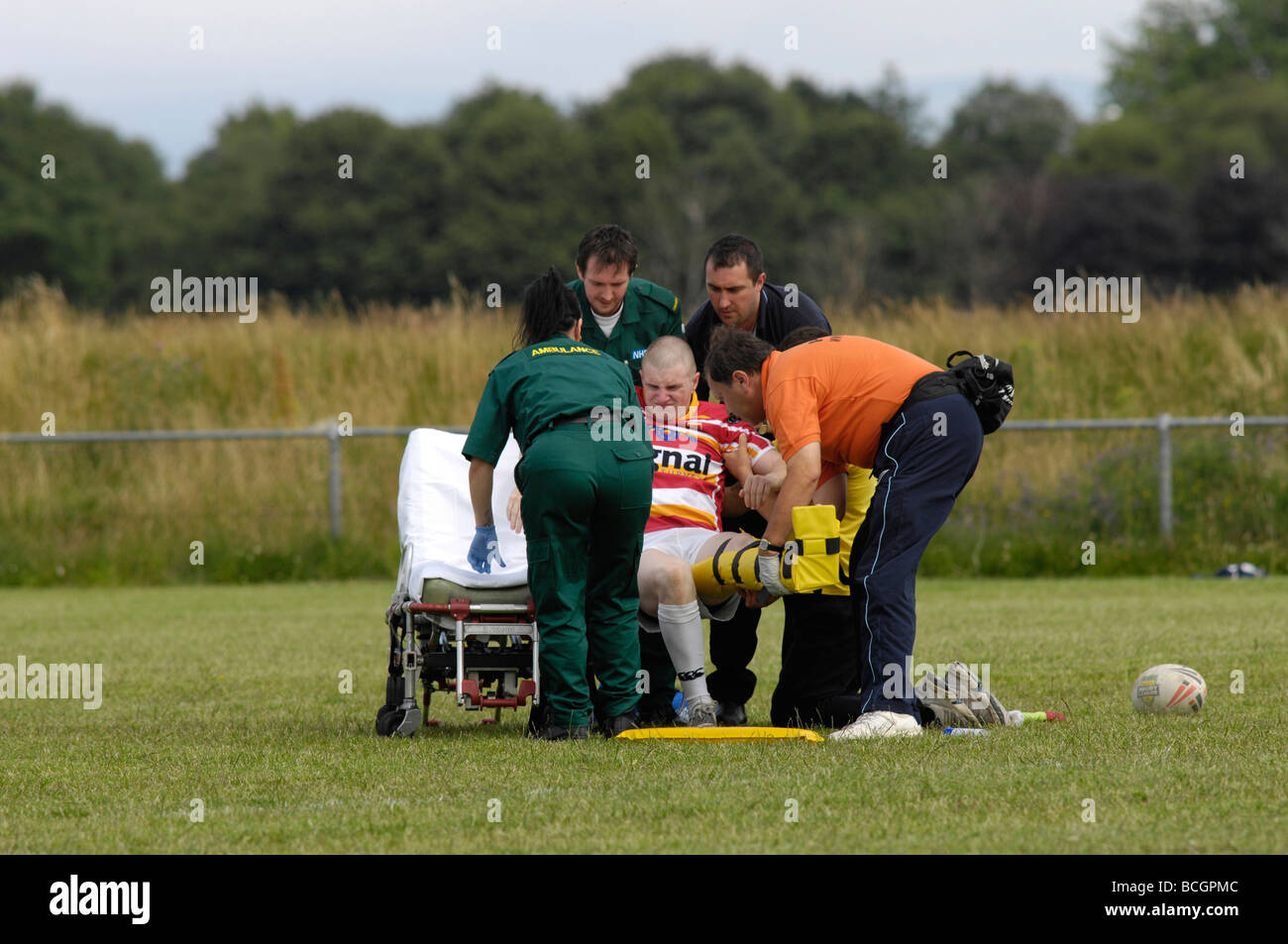 injured rugby player is helped by paramedics Stock Photo - Alamy