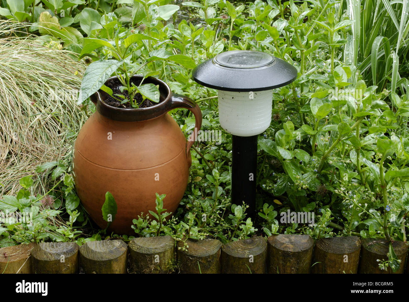 Solar light with pot in the garden Stock Photo - Alamy