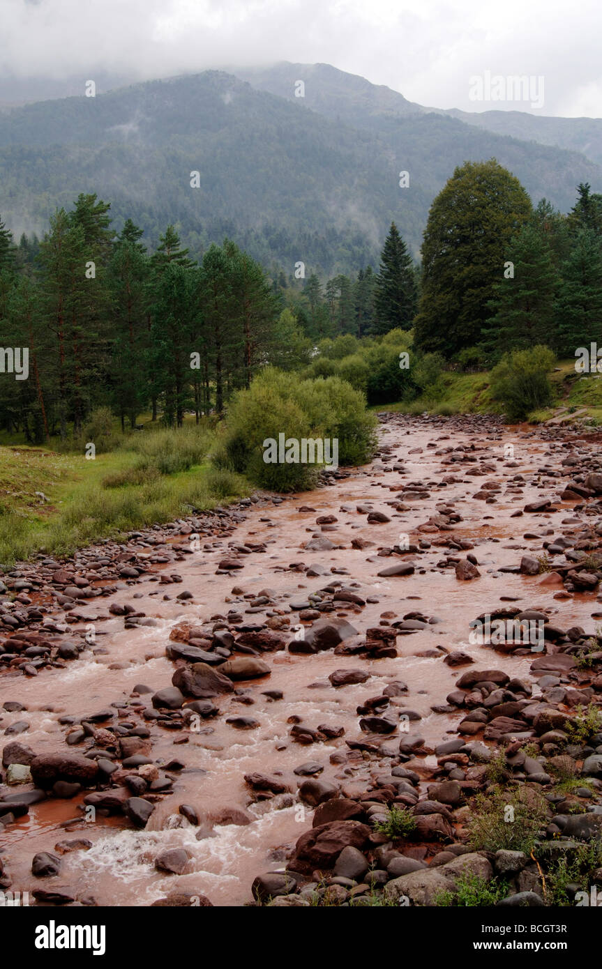 red stream flowing through hecho valley spain in Spanish Pyrenees Stock ...