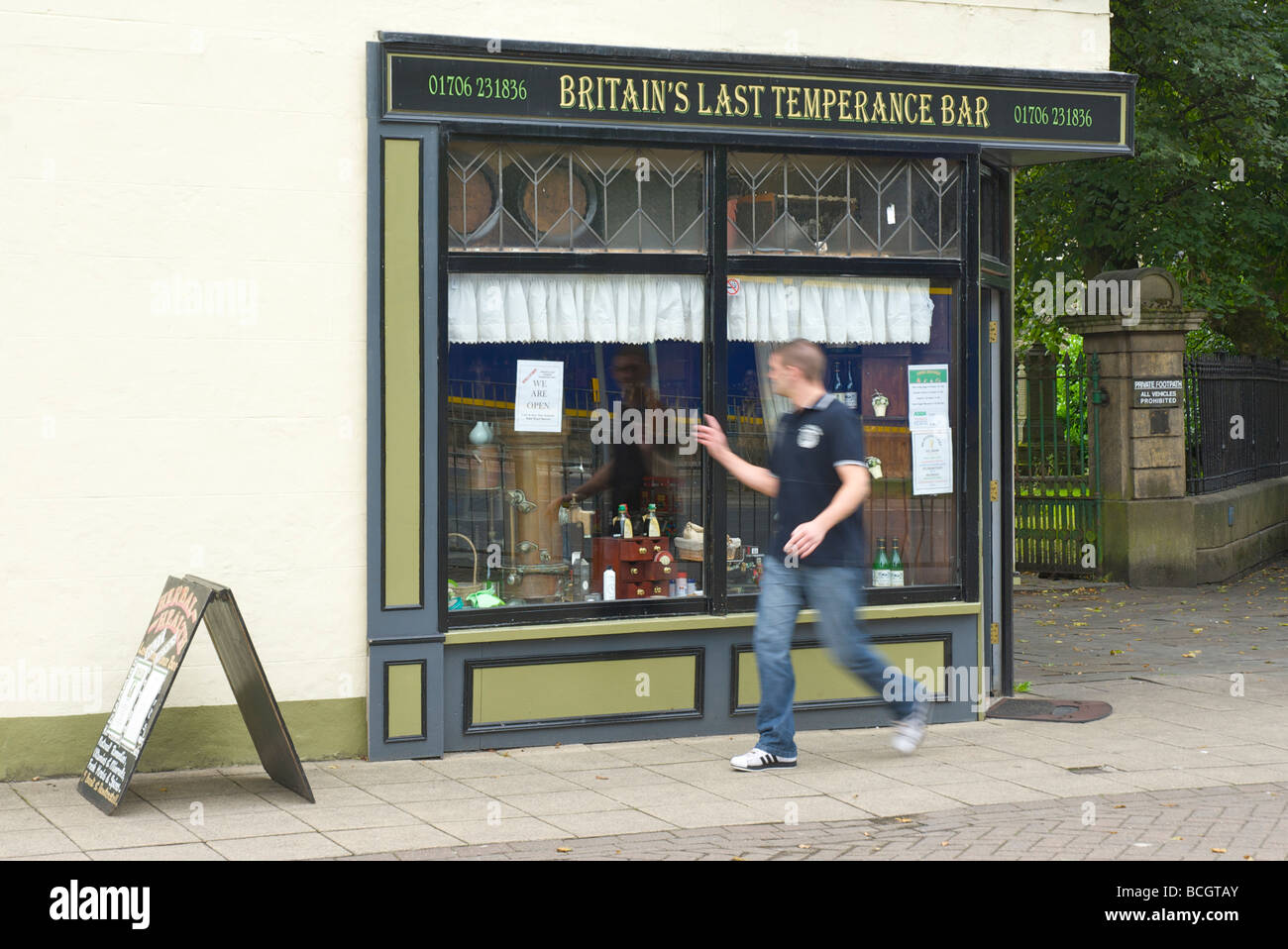 Man walking past Fitzpatrick's Herbal Health temperance bar ...