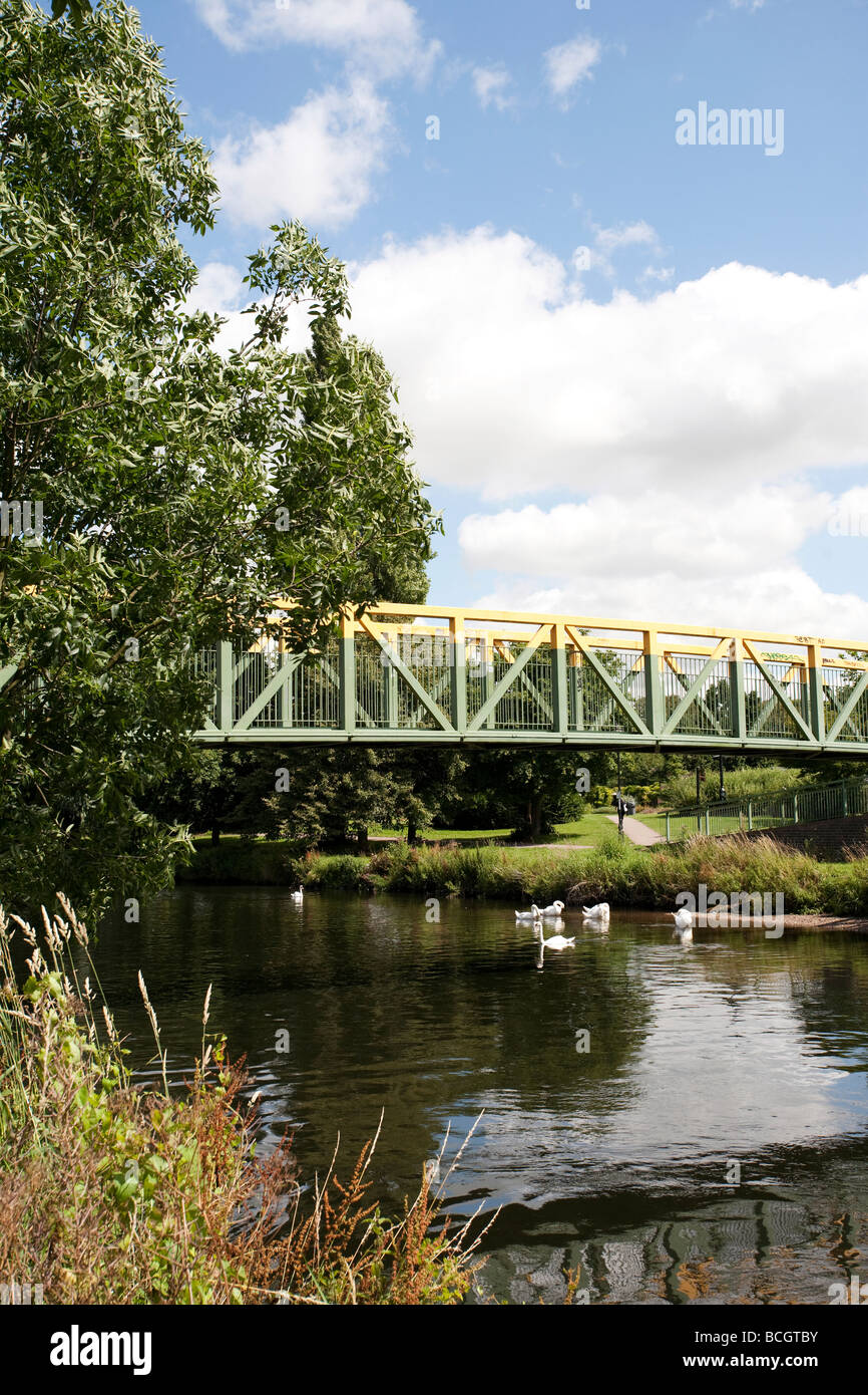 yellow and green footbridge over calm river Stock Photo - Alamy
