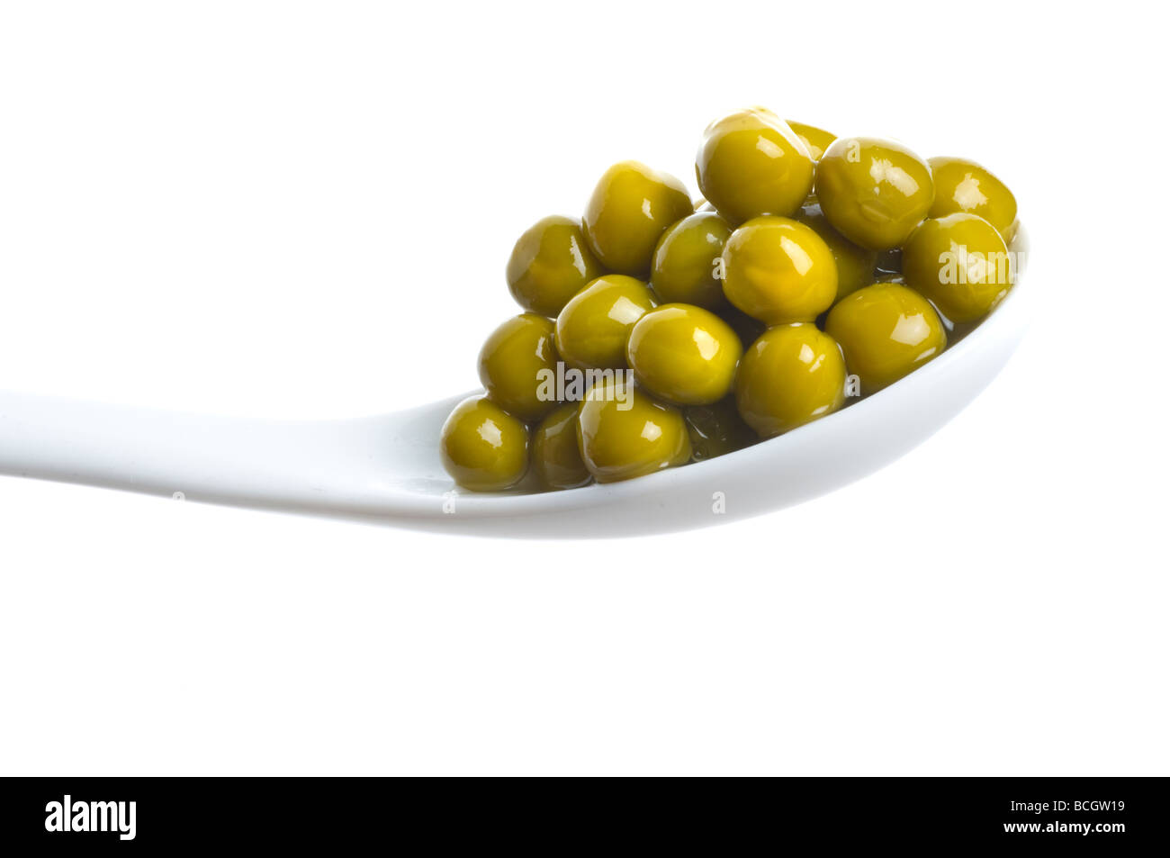Tinned peas in a spoon isoalted Stock Photo - Alamy