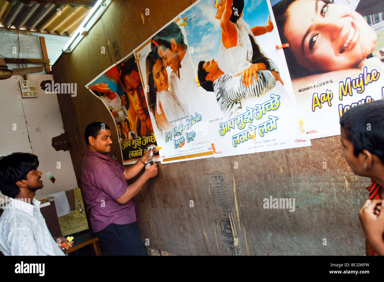 People are putting up Bollywood film posters in the slum area of ...