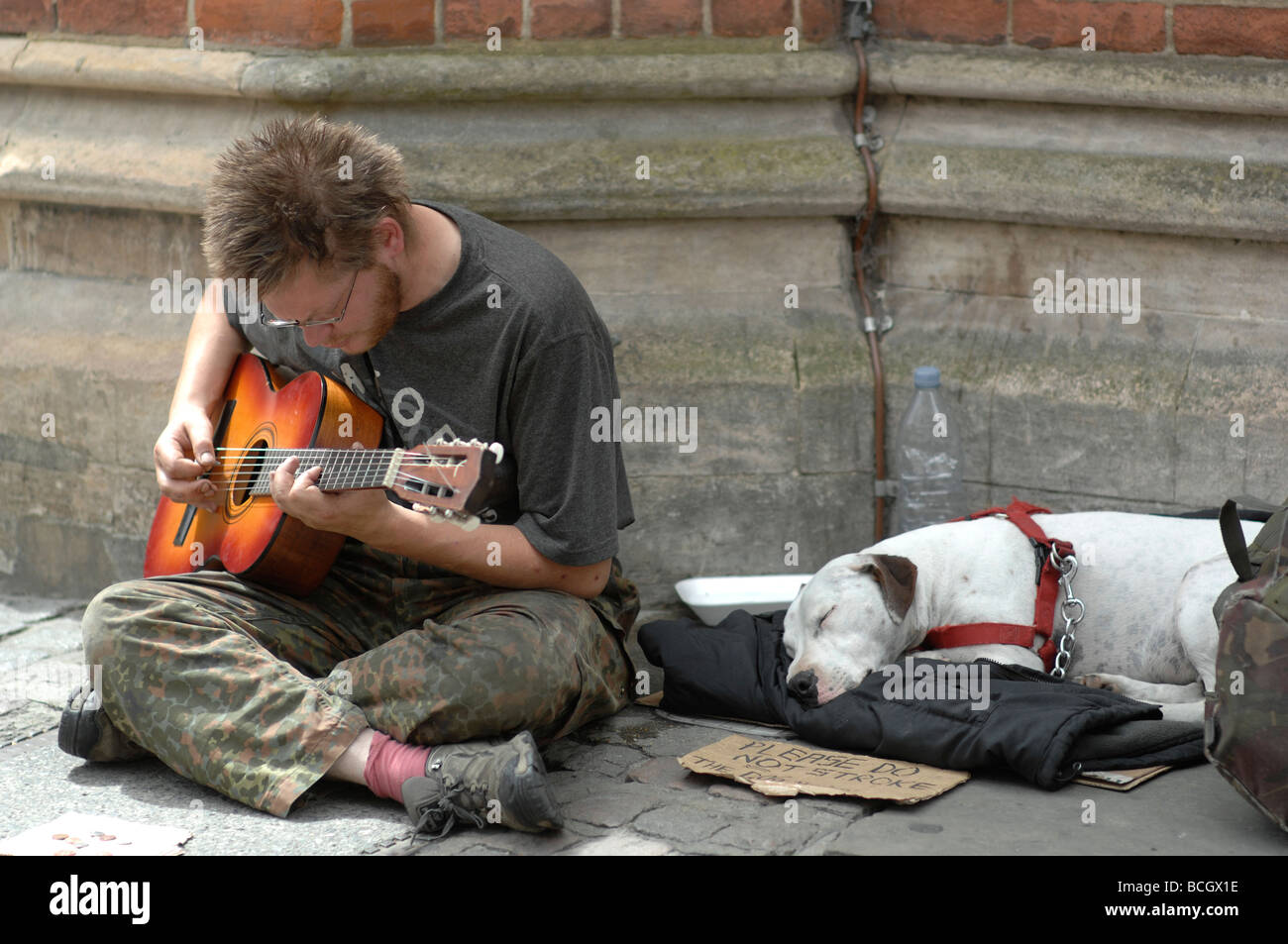 Homeless person busking Stock Photo - Alamy
