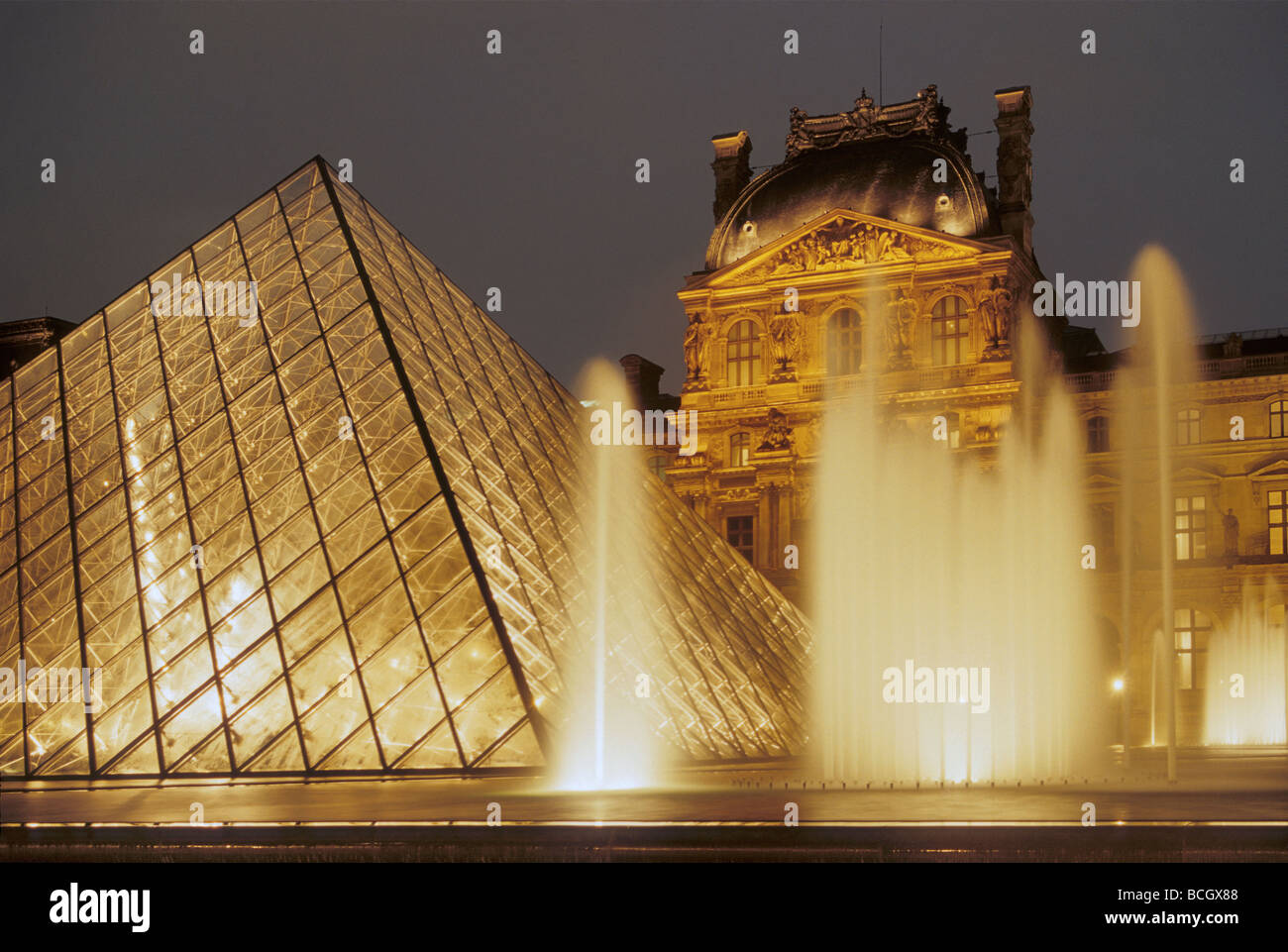 Illuminated Pyramid fountains and Pavillon Denon at Musee du Louvre at ...