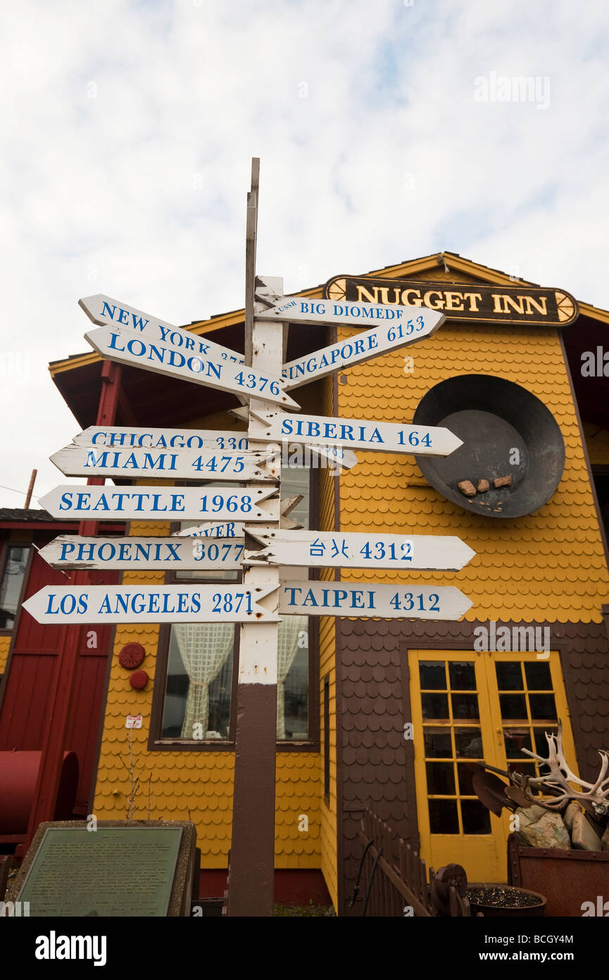 SIGN WITH DISTANCES TO NEAREST CITIES NUGGET INN NOME ALASKA Stock ...