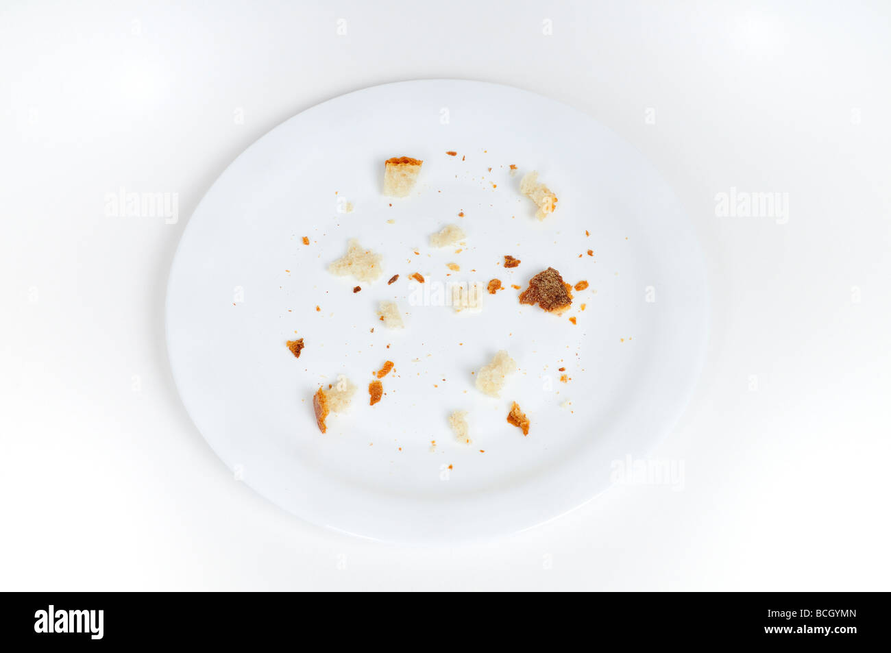 Bread crumbs on plate, white background Stock Photo - Alamy