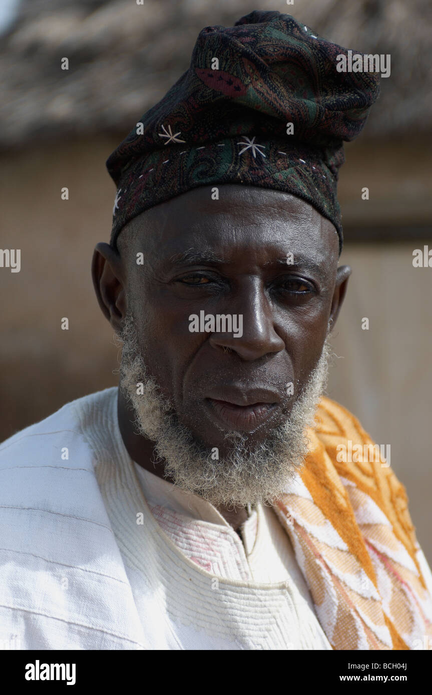 African chief in traditional dress in front of rondavel in Tamale Stock ...