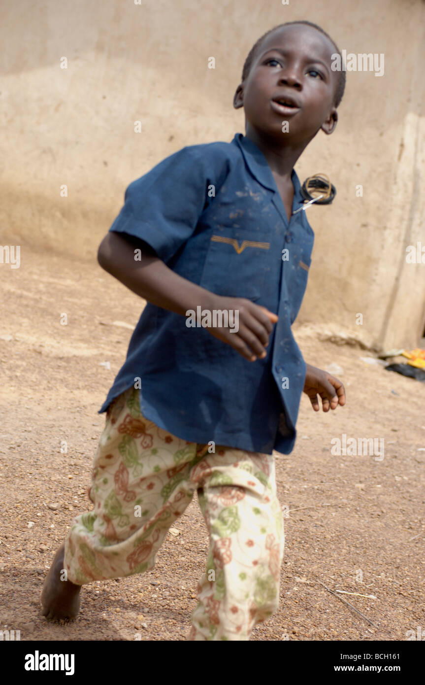Child running in village in Tamale Stock Photo - Alamy
