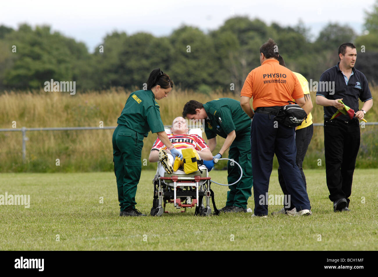 injured rugby player is helped by paramedics Stock Photo - Alamy