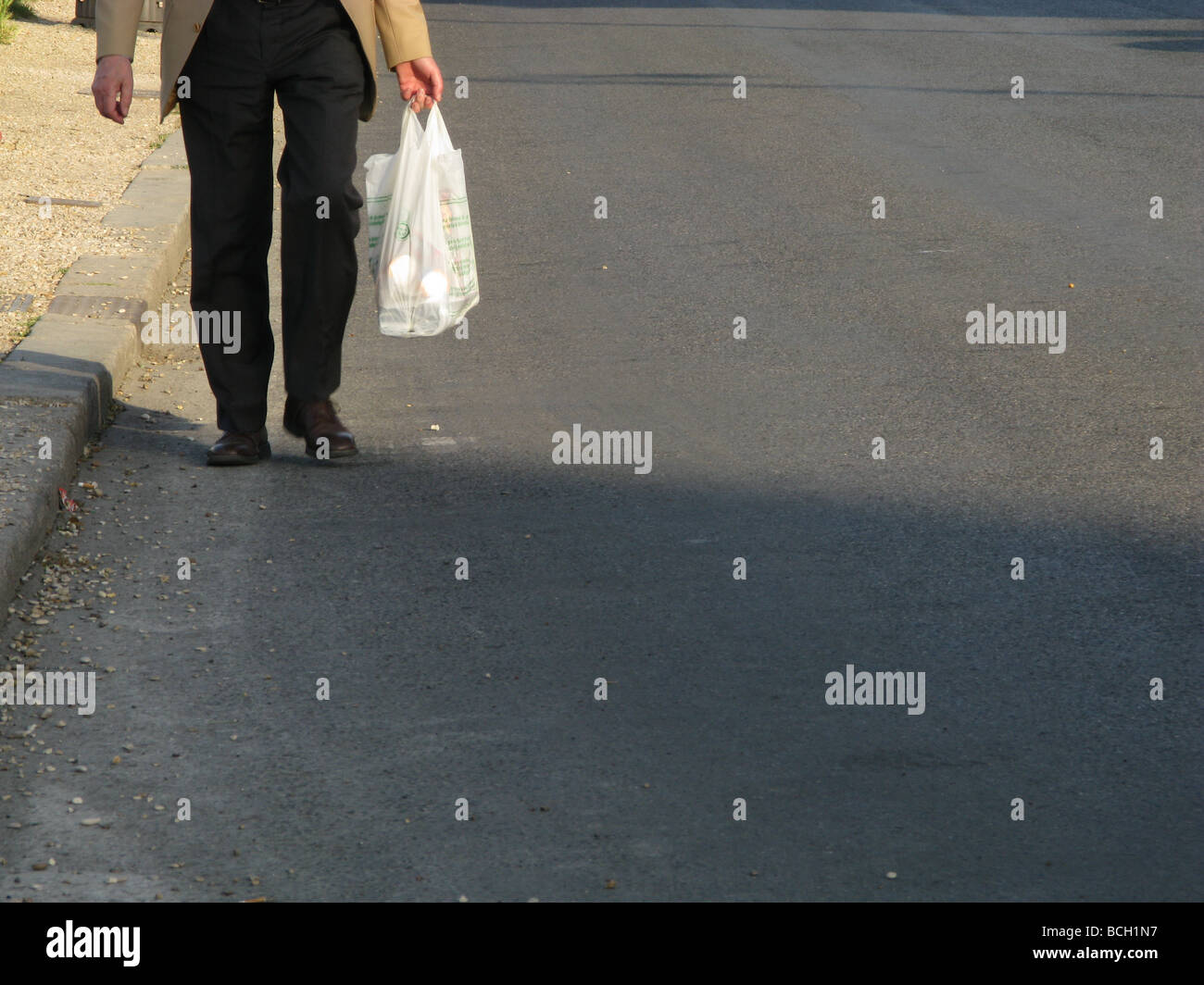 man with shopping bag in street in city town Stock Photo - Alamy