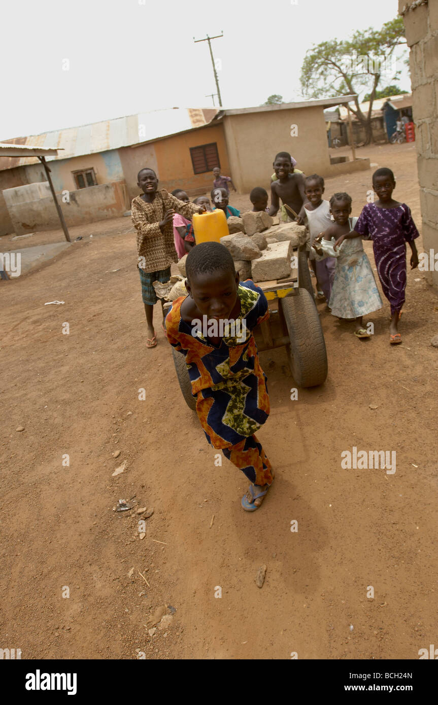 Children pulling heavy cart in Tamale Ghana Stock Photo - Alamy