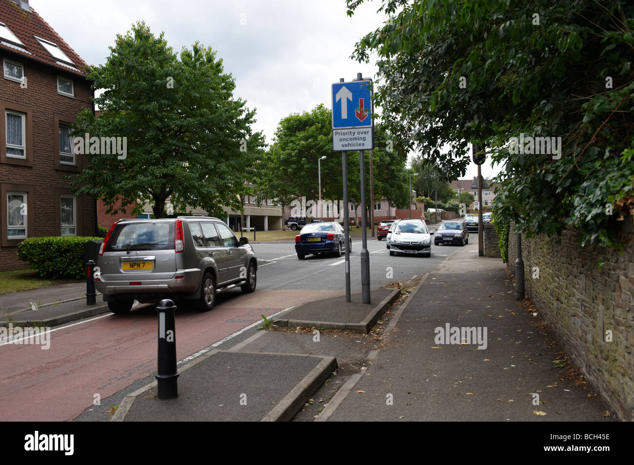 Street sign traffic priority over oncoming traffic Stock Photo - Alamy