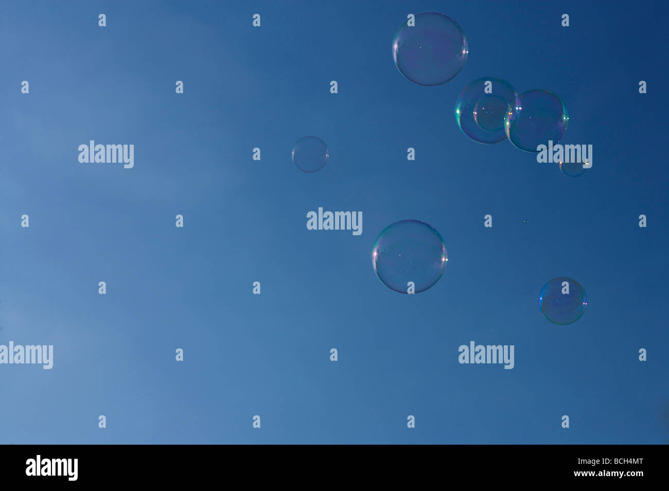 Bubbles floating in a blue sky Stock Photo - Alamy