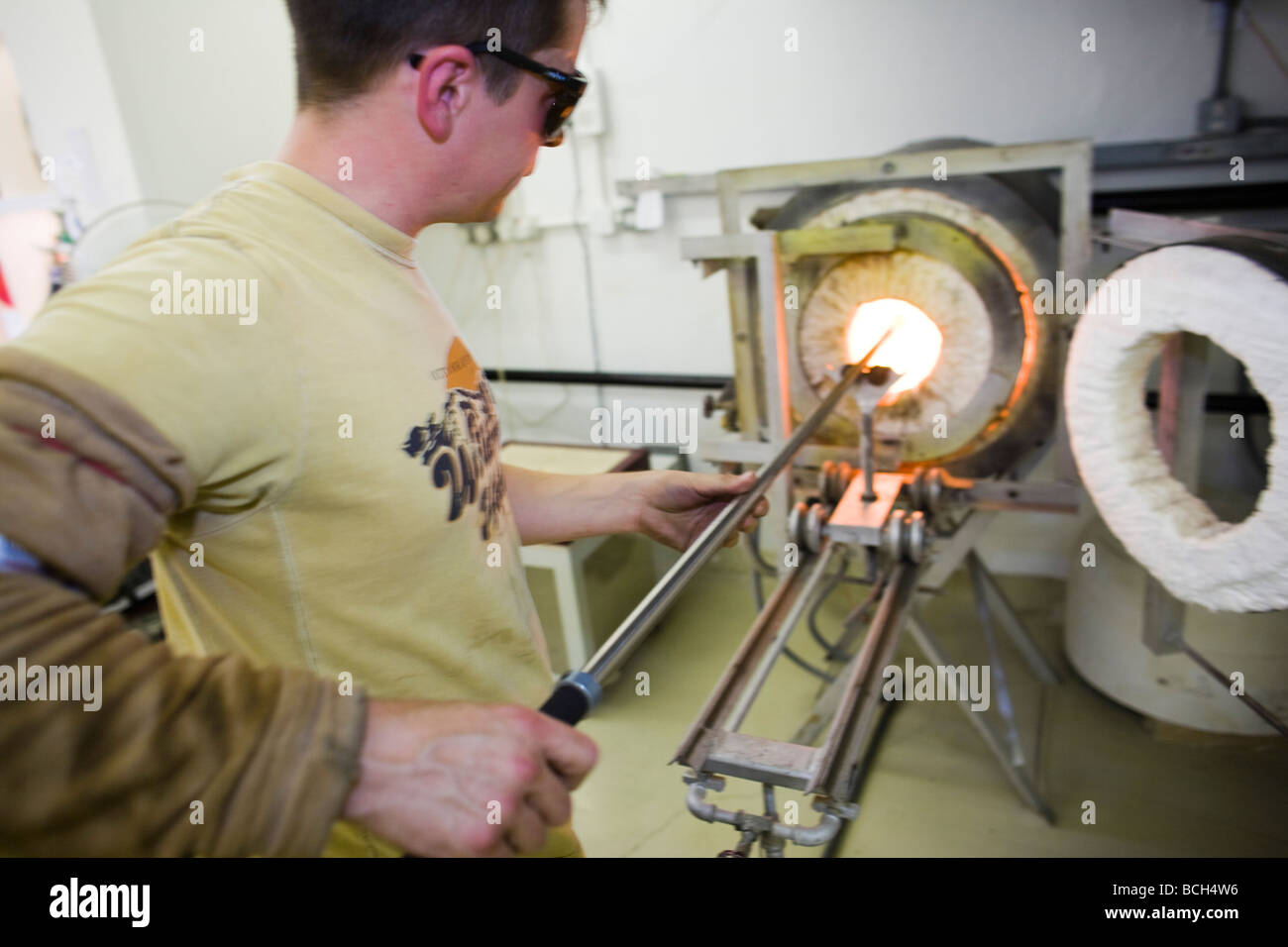 Colin Hawkins, glass blower at the Loco glass studio creating blown ...
