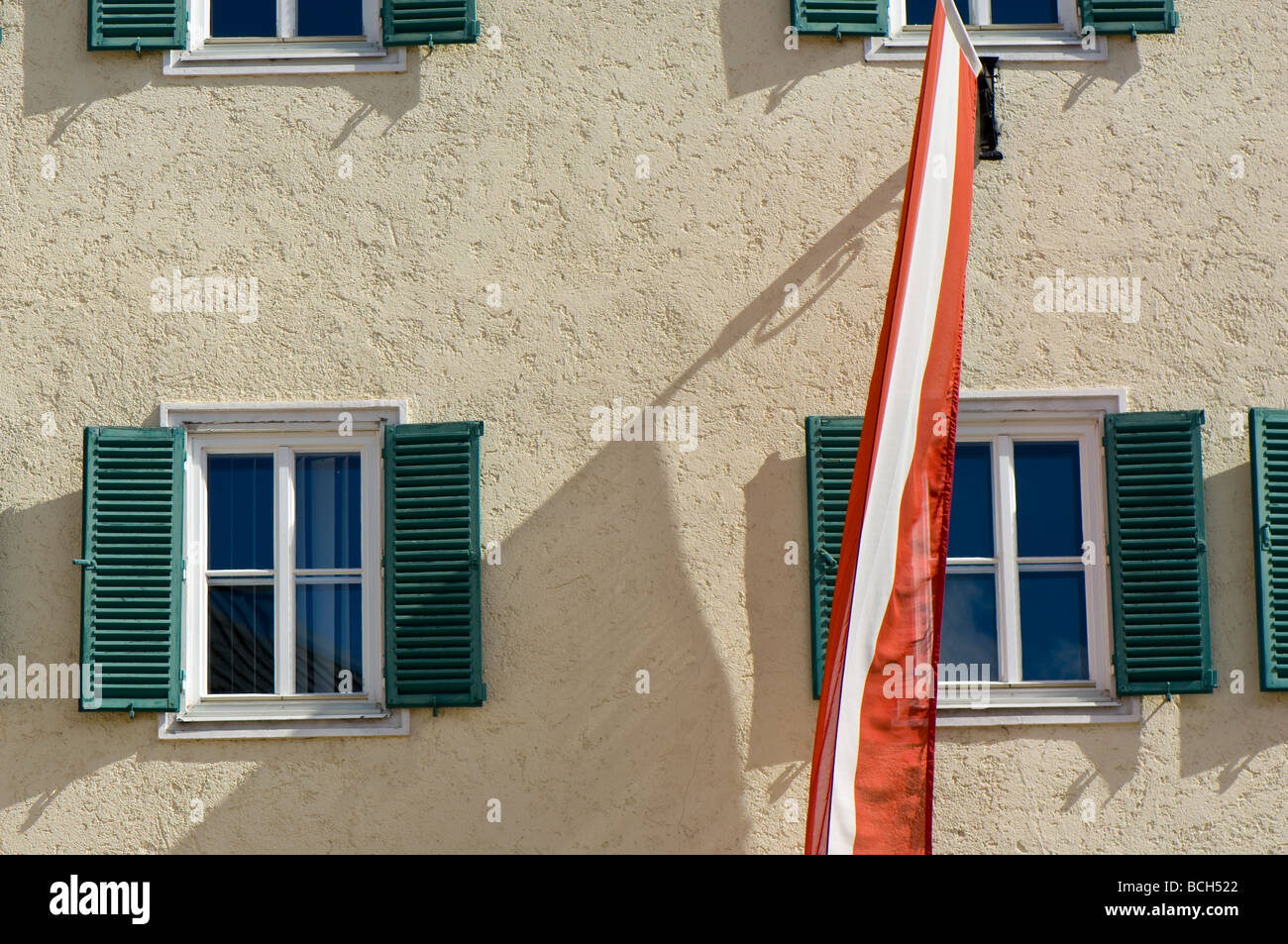 Elongated Austrian flag being flown outside a building with traditional ...