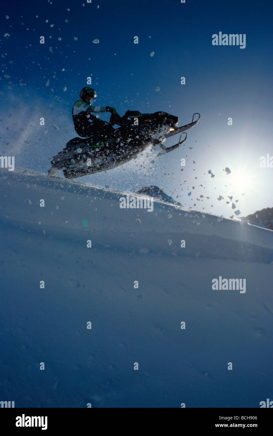Snowmobiler jumping snow drift Southcentral Alaska Stock Photo - Alamy