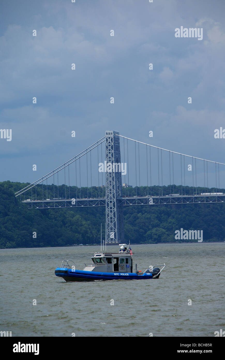 NYPD police boat passing by George Washington bridge Stock Photo - Alamy